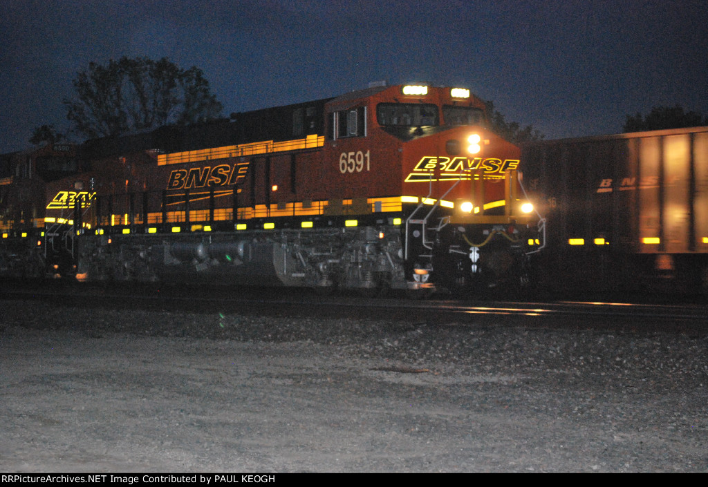 BNSF 6591 with Her Sister C4 BNSF 6590 behind Her roll past an Empty Coal Train as they Head ...